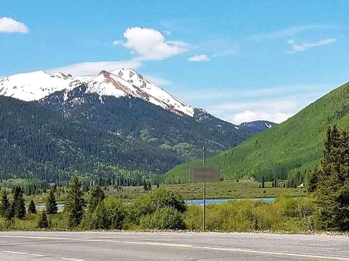 Snow-dusted peaks tower over green valleys where even the mountains seem to be showing off their best angles.