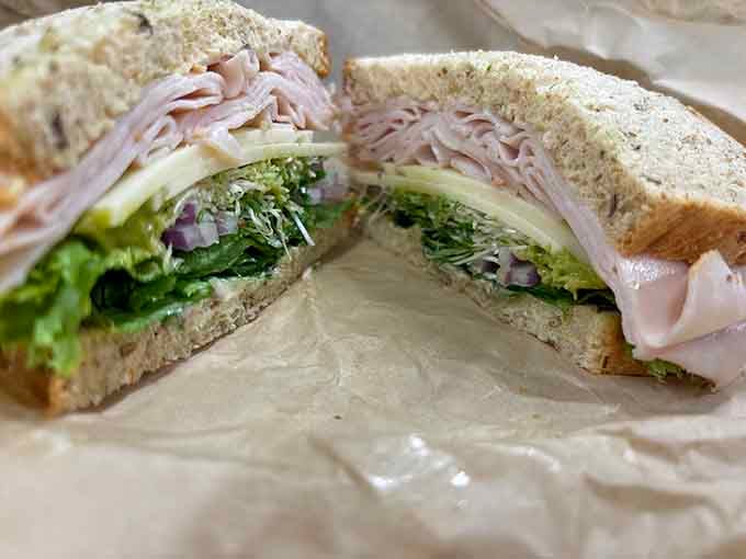 Look at those perfectly stacked layers of turkey and crisp vegetables on hearty bread, a masterclass in sandwich architecture.