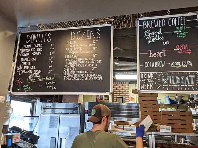 Chalkboard menus reveal the daily donut lineup, making decision-making deliciously difficult every single visit.