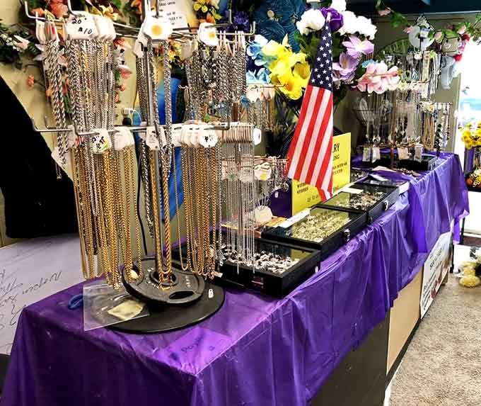 Purple tablecloths mean serious jewelry business, where chains and baubles sparkle like a treasure chest exploded tastefully.