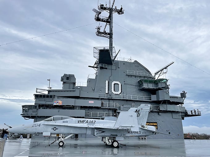 The Blue Angels' F/A-18 Hornet gleams in patriotic splendor, reminding visitors that some jobs require equal parts skill and courage.