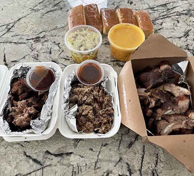 Behold the holy trinity: pulled pork, brisket, and ribs, each one smoky enough to make your taste buds weep with joy.