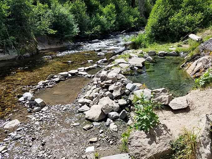 Visitor-built rock walls transform geothermal seeps into custom soaking pools, like nature's own HGTV renovation show.