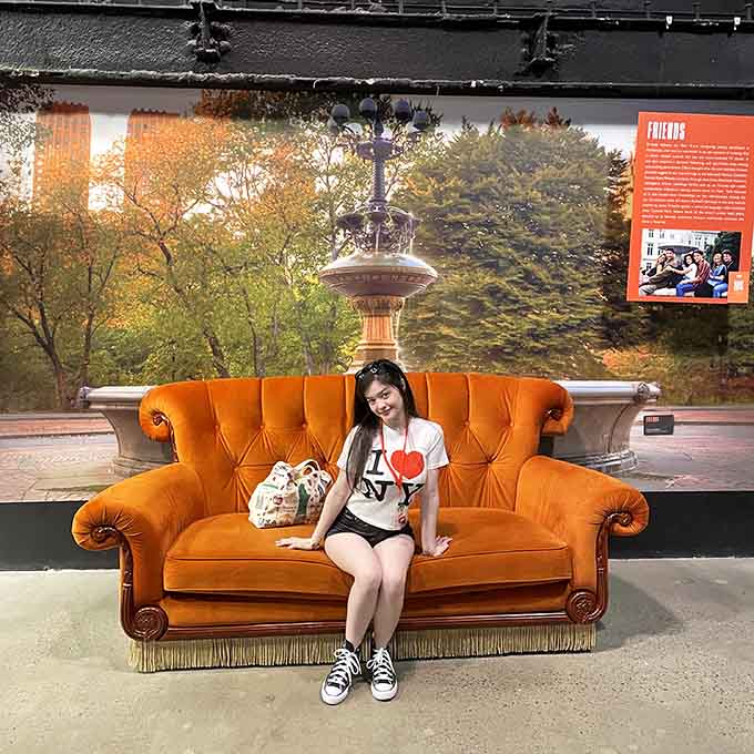 Grab a seat on this iconic orange couch and pretend you're about to spill secrets on a classic talk show.