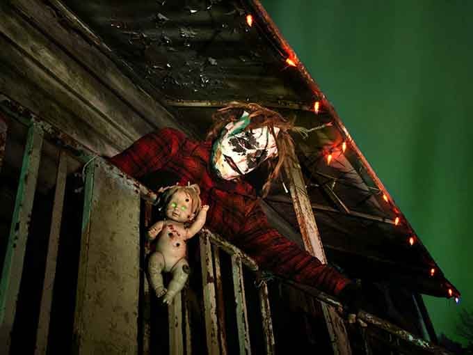 That clown's holding a doll like it's a trophy, which should tell you everything about what happens inside these walls.