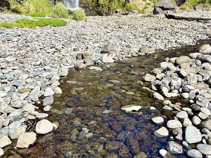 Nature's own rock collection sprawls across the shore, each stone polished smooth by countless patient tides.