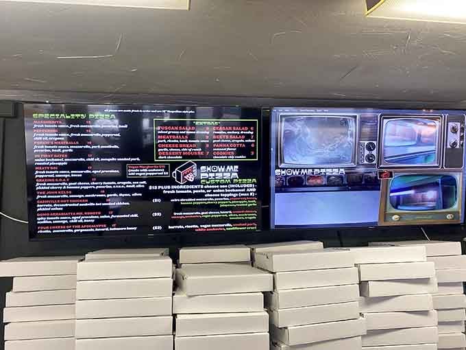 Stacks of pizza boxes ready for action, with vintage TV sets adding retro charm to this modern operation.