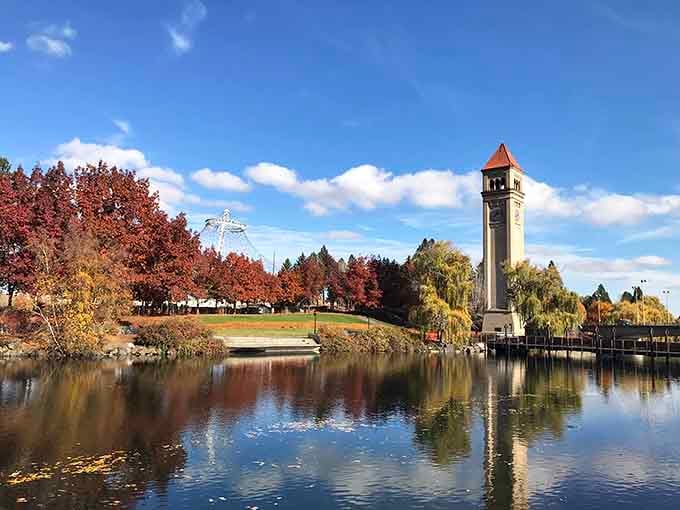 Riverfront Park's iconic clock tower reflects perfectly in the water, creating postcard views without the postcard prices.