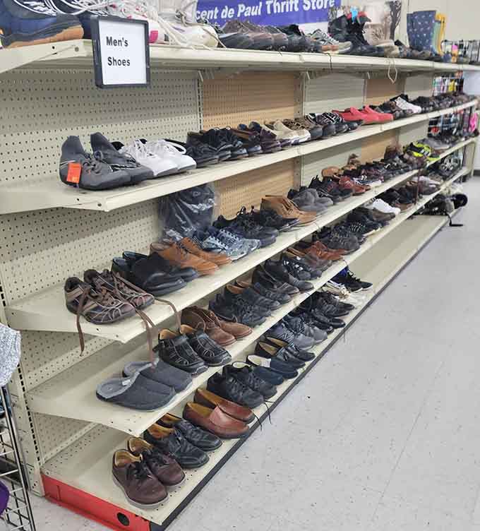 Rows of men's shoes waiting for their second act, because good footwear deserves another chance at life.