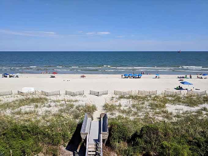 Natural dunes frame the beach like Mother Nature's own velvet rope, keeping things beautifully unspoiled and peaceful.