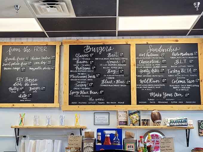 Hand-lettered menu boards tell you everything you need to know: burgers, cheesesteaks, and pure deliciousness await.