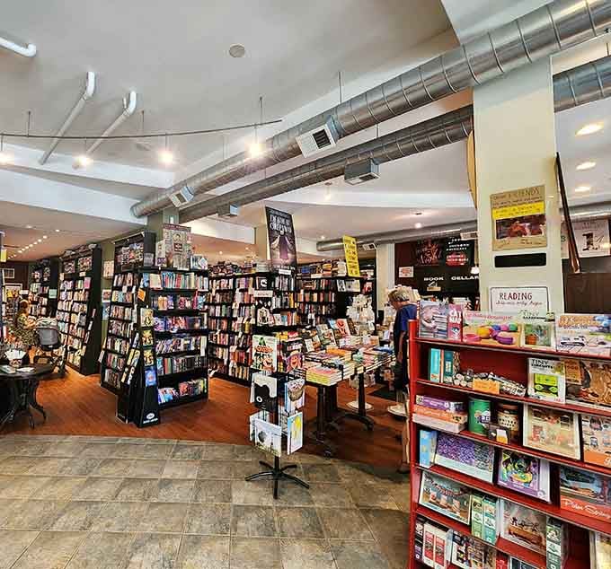 Exposed ductwork meets endless shelves in a space that proves bookstores can be both industrial and inviting.