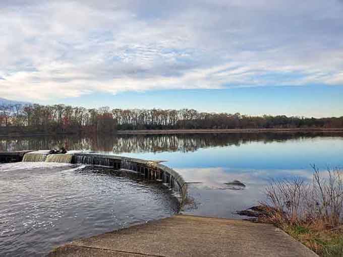 The lake's mirror-perfect surface makes you wonder if you've stumbled into a postcard come to life.