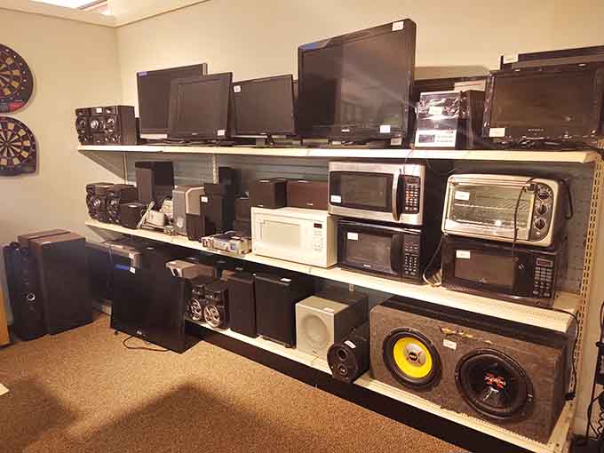 Rows of electronics and microwaves ready for their comeback tour, proving technology deserves second chances too.