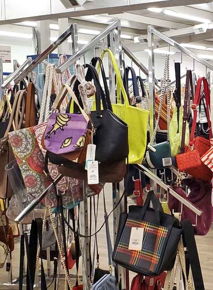 A rainbow of handbags dangles like fashion fruit, each one carrying stories from trips that took unexpected detours.