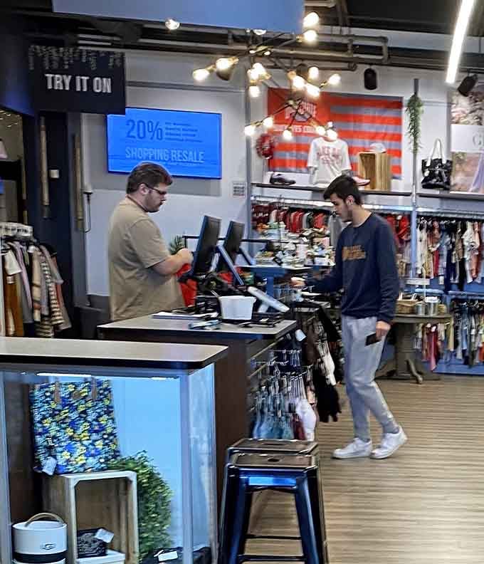Modern checkout counter with digital displays showing your savings, because watching money stay in your wallet is entertainment.