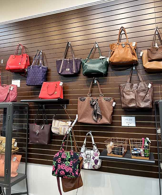 Designer handbags waiting patiently on the wall, blissfully unaware they're about to cost a fraction of retail.