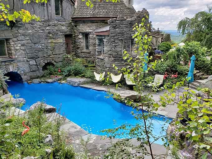 That impossibly blue pool nestled against castle walls makes every other backyard look tragically ordinary.