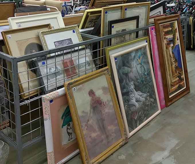 Someone's discarded art collection becomes your gallery wall, one frame at a time, stories included free.