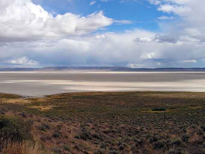The cracked earth stretches endlessly here, like nature's own jigsaw puzzle waiting beneath dramatic storm clouds.