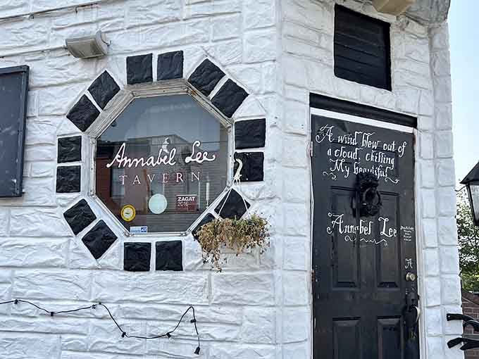 Gothic elegance meets neighborhood charm with Poe-inspired quotes adorning this striking white-painted tavern entrance.