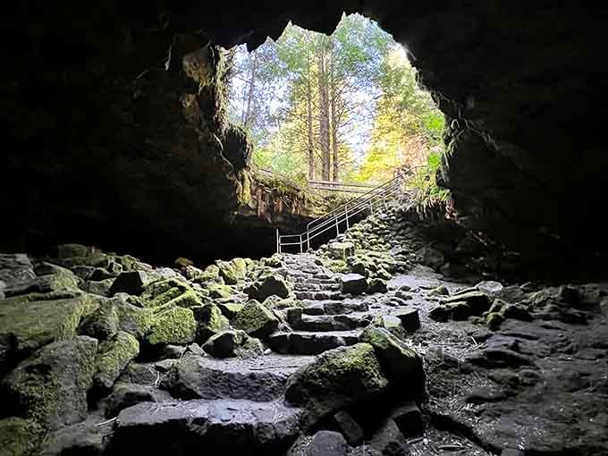 Looking up from darkness toward daylight, this ancient lava tube stairway feels like climbing out of Earth's basement.