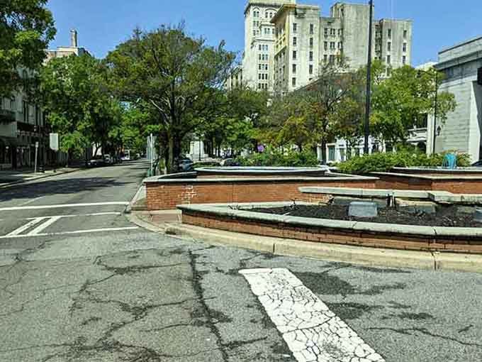 That brick fountain anchors the plaza like a town elder, watching over streets that remember slower times.