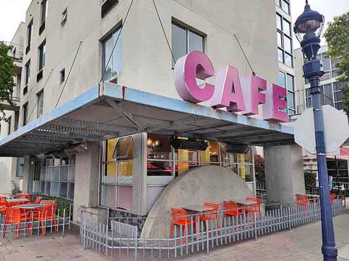 The pink "CAFE" sign hangs like a friendly invitation to the best breakfast you'll have all week.