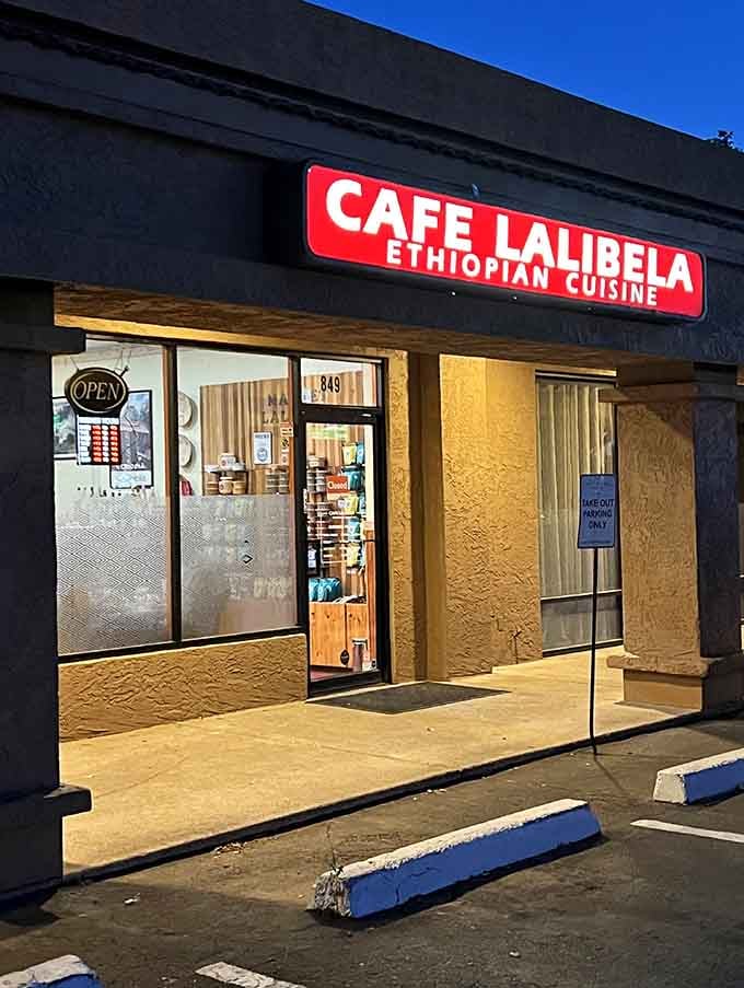 That bold red sign beckons like a beacon, promising authentic Ethiopian flavors hiding in this unassuming strip mall spot.