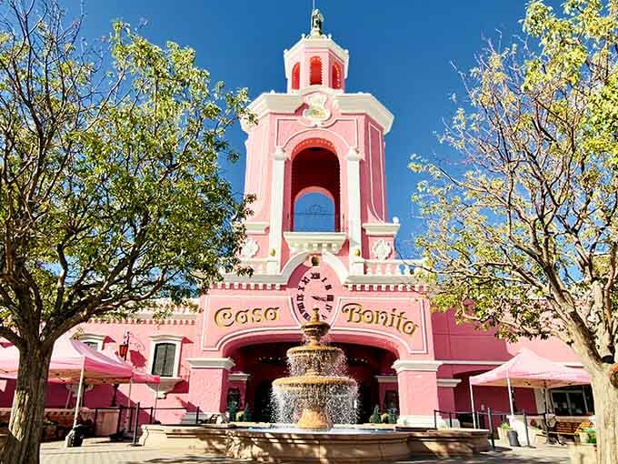 Pink palace alert! Casa Bonita rises like a cotton candy dream, promising cliff divers and sopapillas under one magical roof.