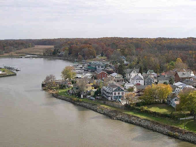 Chesapeake City hugs the waterfront like it was born there, with boats bobbing and autumn colors painting the hillsides.