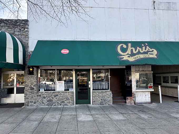 That vintage green awning and stone facade whisper stories of countless hot dogs served since Eisenhower was president.