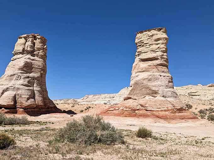 These ancient hoodoos stand like chess pieces painted in purple, orange, and cream by millions of years of patient erosion.