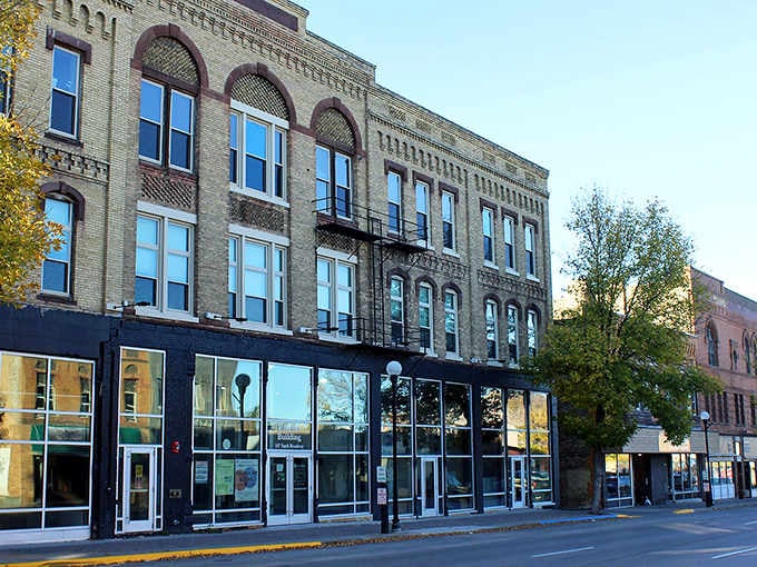 Historic brick facades meet modern storefronts on this charming Main Street, where yesterday's architecture frames today's small-town dreams.