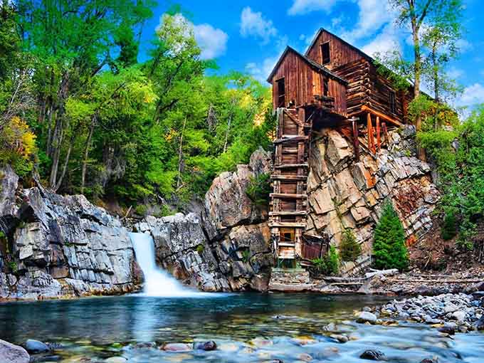 This wooden mill perched on a rock defies gravity and common sense in the most photogenic way possible.