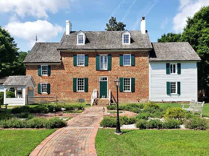 That brick walkway leading to green shutters practically whispers "welcome" on sunny days like this.