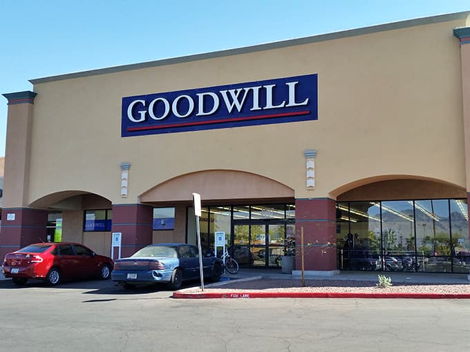 The classic blue Goodwill sign stands proud against desert skies, promising quality finds at prices that make sense.