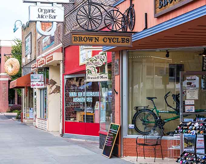 Brown Cycles anchors this streetscape like the neighborhood friend who's always got exactly what you need&mdash;and a good story besides.