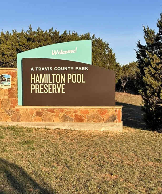 This cheerful sign welcomes you to one of nature's most spectacular swimming holes, where limestone cliffs meet crystal-clear water.