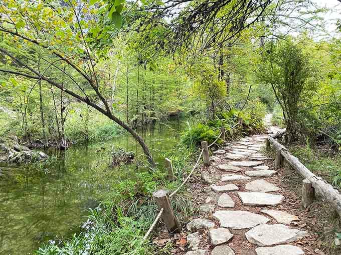 This peaceful stone pathway winds alongside crystal-clear water, proving that paradise doesn't require a plane ticket after all.