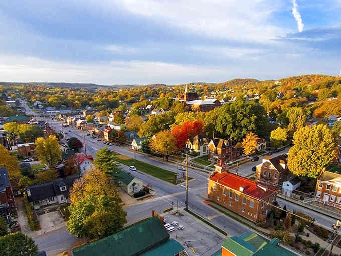 Golden autumn trees blanket the hillsides surrounding this charming river town like nature's own quilt.
