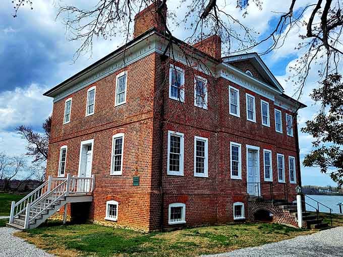 Georgian brick perfection sits waterside like a proper English manor that wandered across the Atlantic and decided to stay.