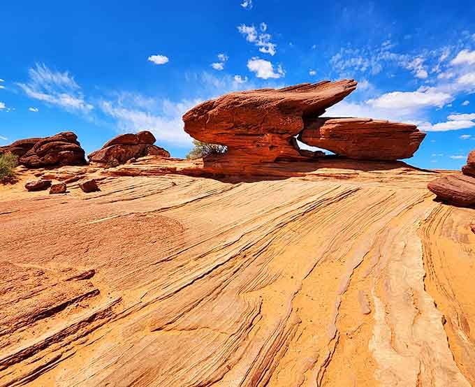 The swirling patterns in these balanced rocks show how wind and water sculpted the landscape over millions of years beautifully.