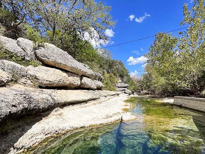 Crystal-clear water reveals limestone shelves below, creating natural infinity pools that seem almost too perfect to be real.