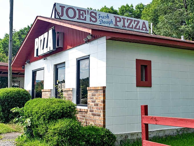 That bold red roof announces fresh pizza ahead, and the "Fresh Dough" promise isn't just clever marketing here.