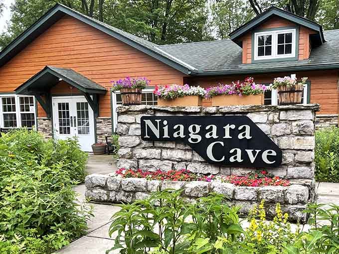 Cheerful flowers frame the entrance to this underground wonder where nature carved its own cathedral below.