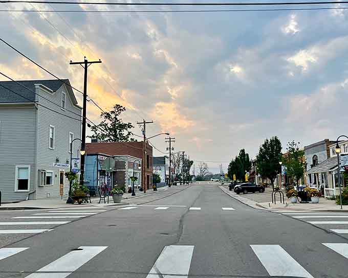 Sunset paints the sky in watercolor hues above this charming main street's vintage storefronts.