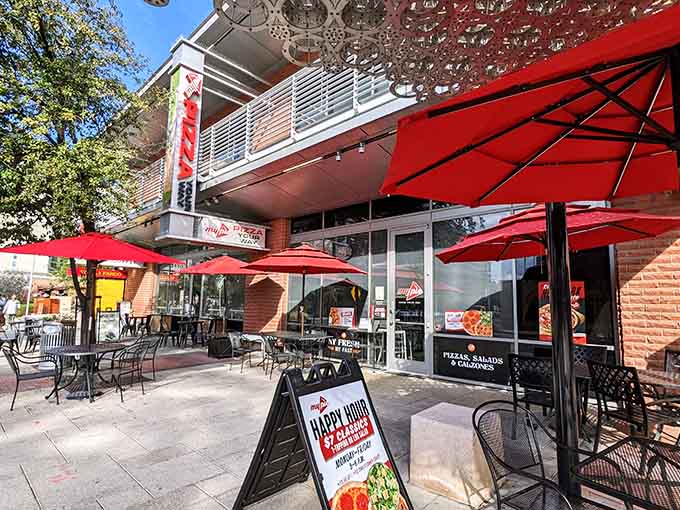 Red umbrellas dot the patio like delicious breadcrumbs leading hungry college students and pizza lovers to carb heaven.
