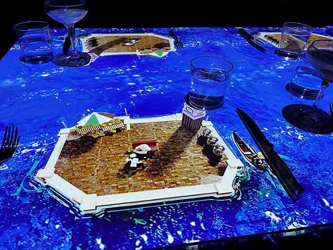 Your dinner table becomes an ocean of swirling blue projections, like dining inside a living screensaver.