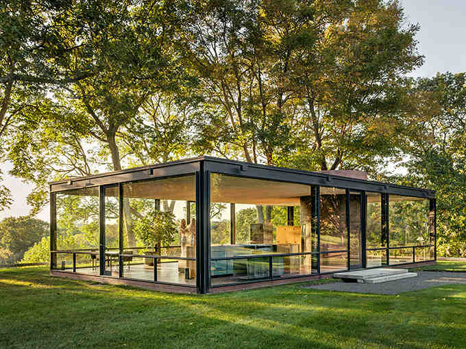 Golden hour bathes this glass pavilion in warm light, blurring the line between architecture and landscape.